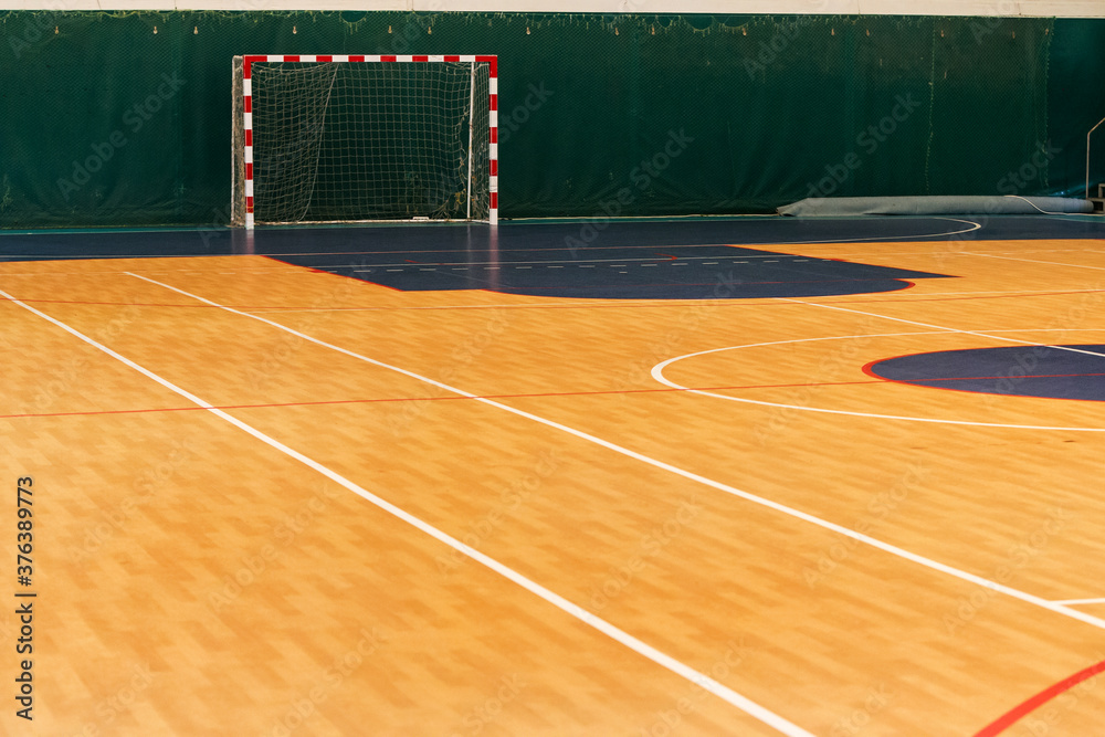 Gym for playing futsal, mini-football. Folded wooden parquet on the ...