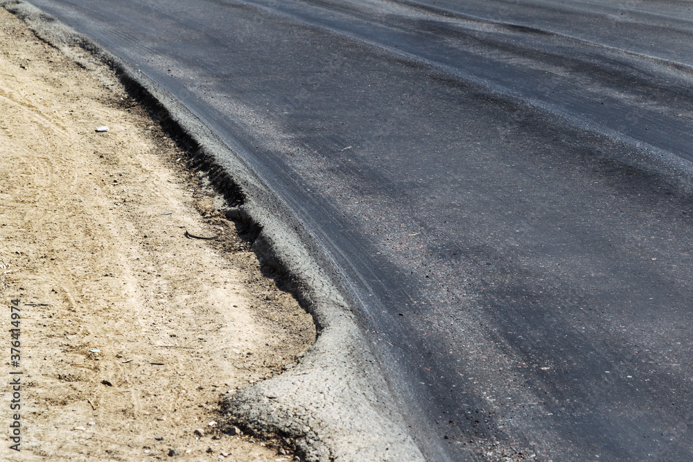 Damaged road, damaged chopped asphalt with potholes and spot. Very bad ...