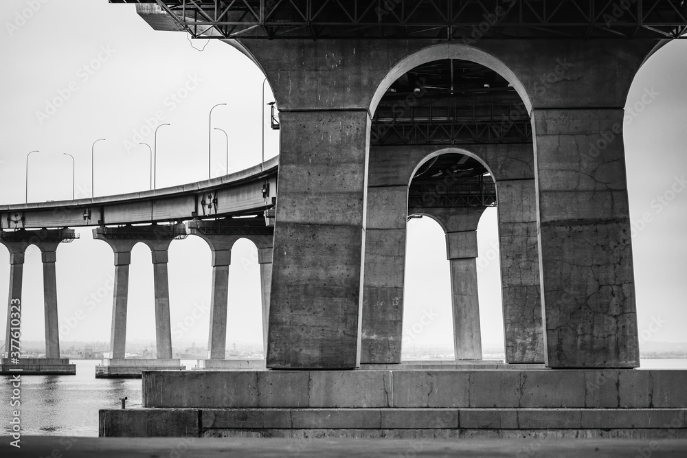 Black and white moody contrasty photo looking at the underneath arches ...
