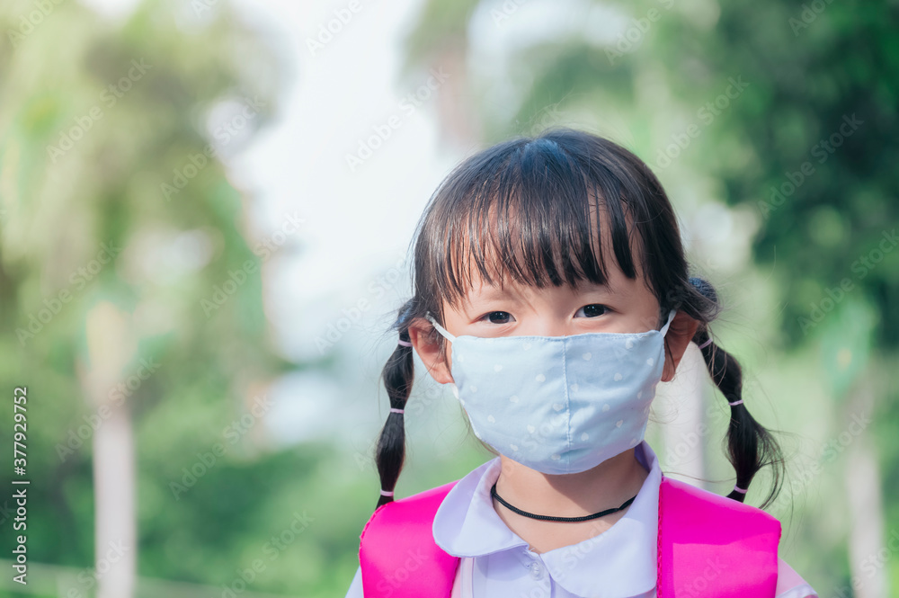 Little school girl has mask protect herself from Coronavirus COVID-19 ...
