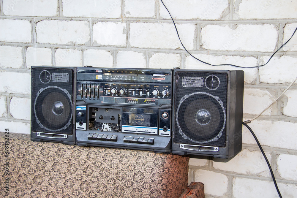 Retro portable radio stereo cassette player. Boombox lays outside on ...