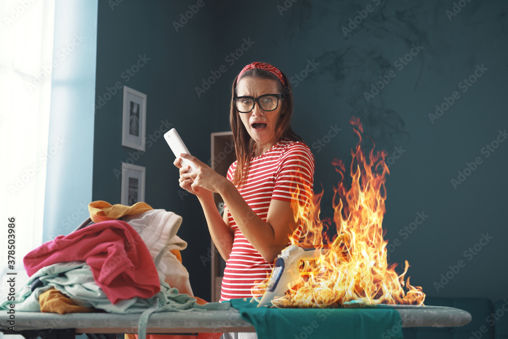 Distracted careless housewife burning clothes with the iron Stock Photo ...
