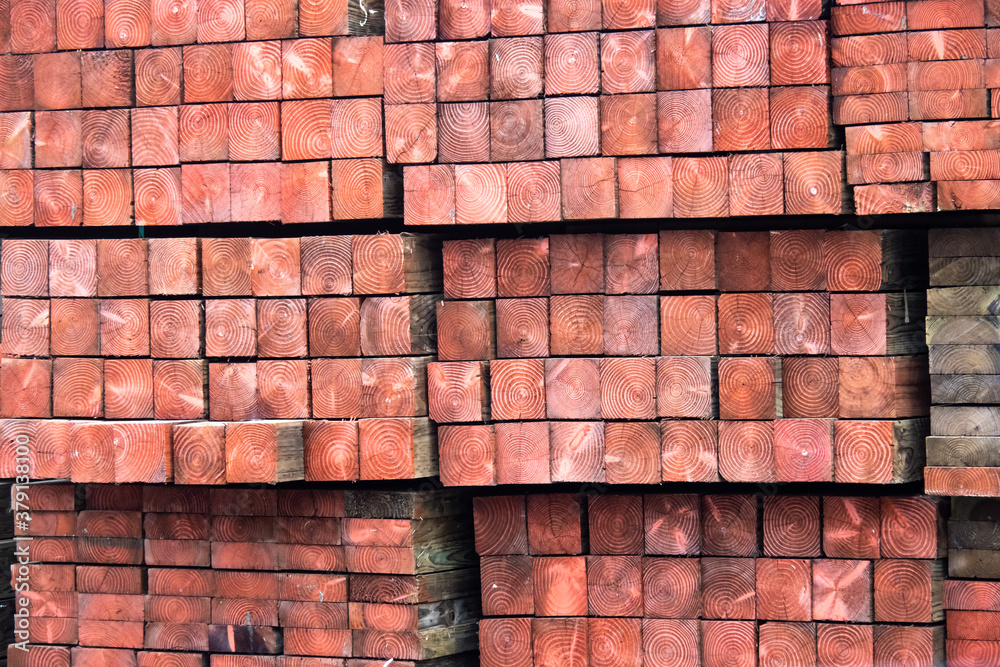 end grain of stacks of heavy industrial pressure treated wood planks ...