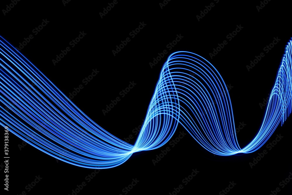 Long exposure photograph of neon blue colour in an abstract swirl ...