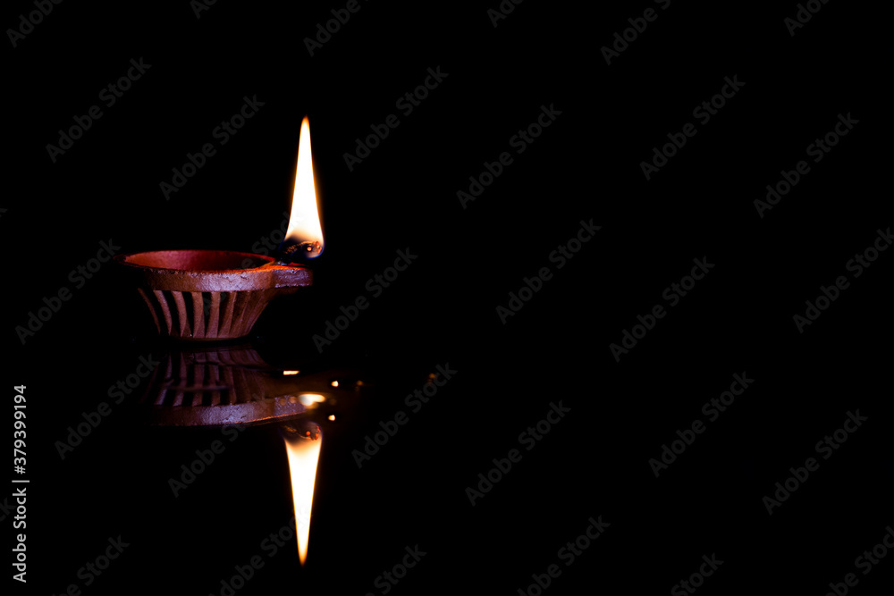 Deepam with a reflection on the wet ground Stock Photo | Adobe Stock