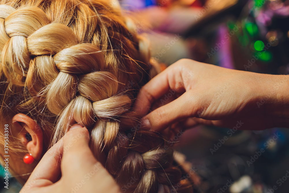 Process of braiding the master weaves braids on her head blond little ...