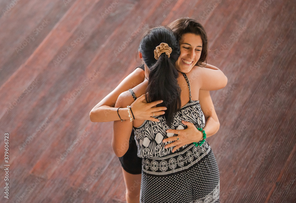 Two young women embracing and giving hugs to each other. Support ...