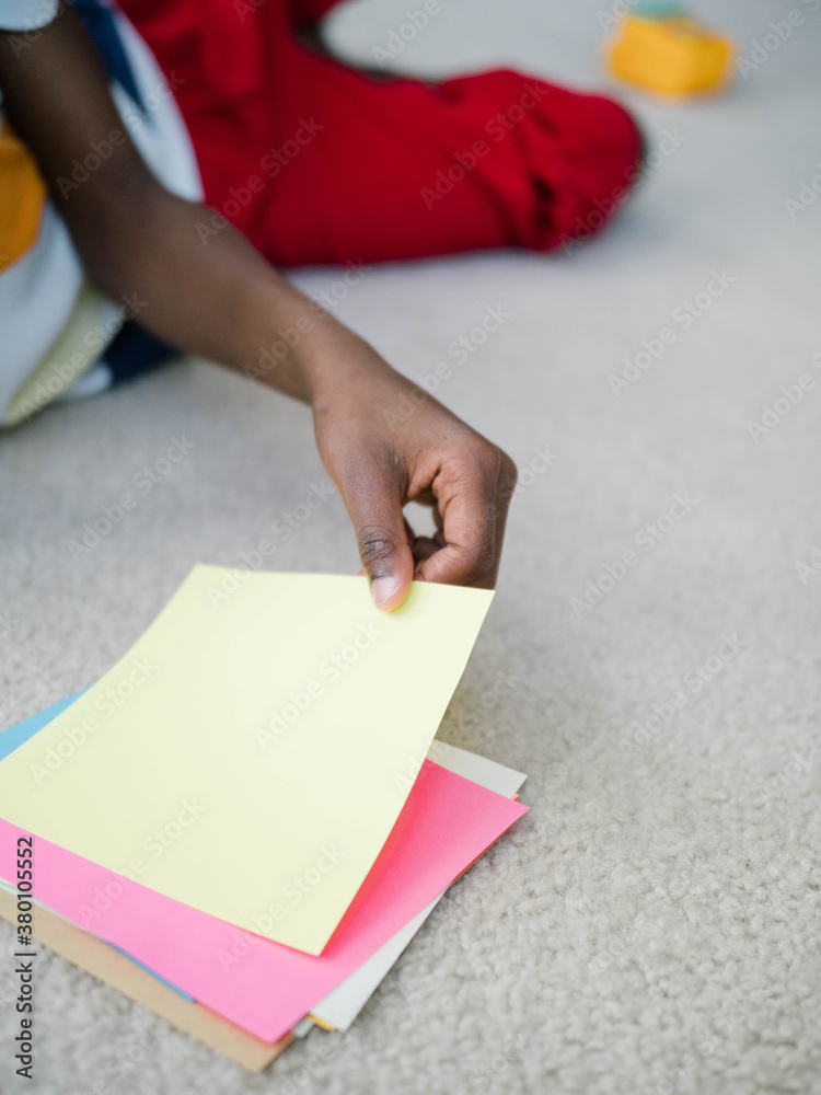 Young boy gathering Origami paper Stock Photo | Adobe Stock