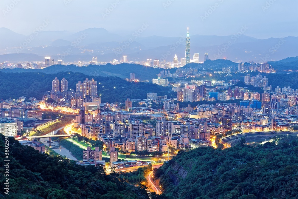 Aerial panorama of overpopulated suburban communities in Taipei at dusk ...