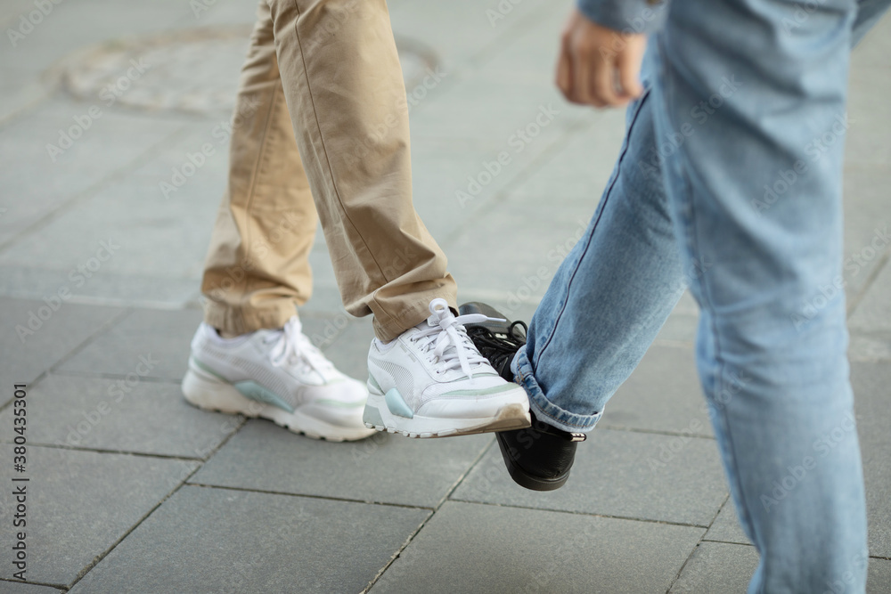 Young people greeting to avoid the spread of coronavirus. Two friends ...
