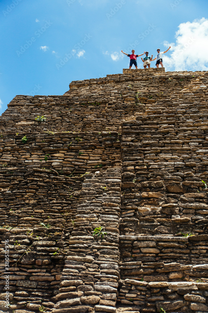 Three victorious men at the top of ancient pre-columbian ruins Stock ...