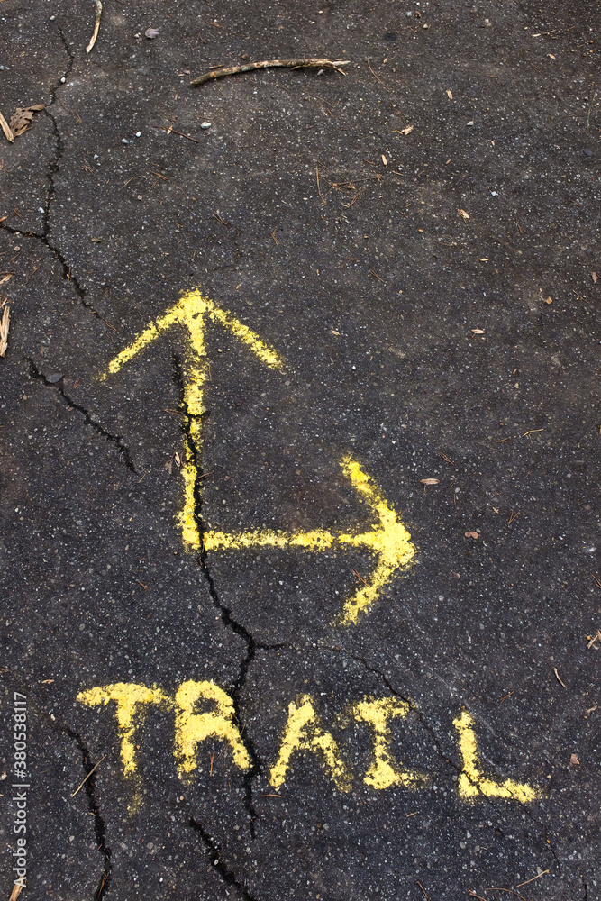 Trail directions painted on paved path at an intersection. Stock Photo ...