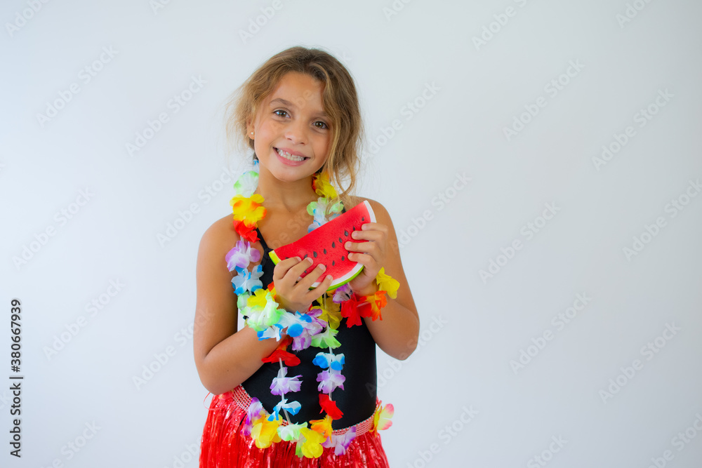 Little girl wearing Hawaiian dress eating watermelon on white ...
