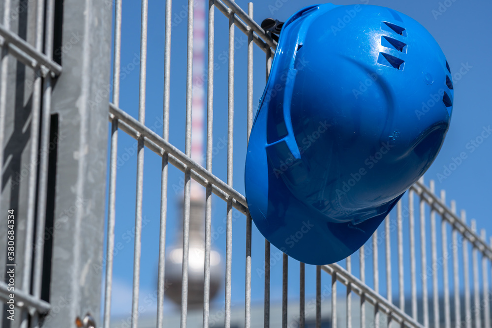 Occupational safety and safety gear. Blue hard hat hanging on ...