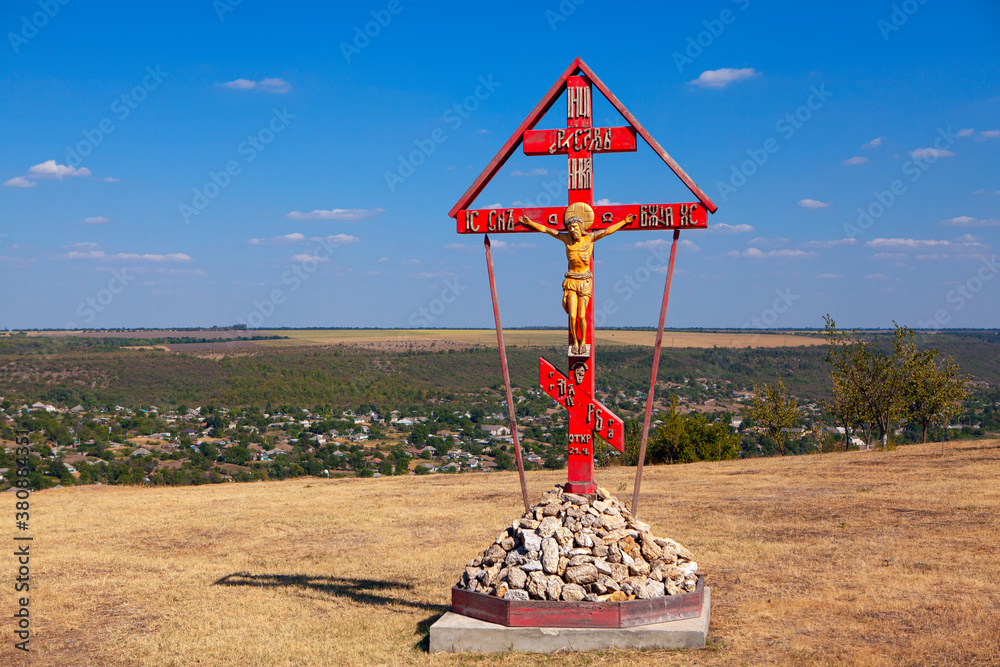 Monument of the Crucifixion of Jesus Christ . Red orthodox Cross with ...