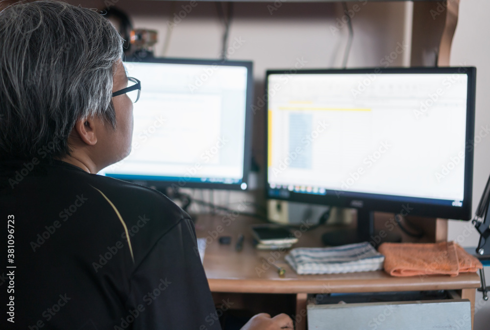 Back view Smart older Asian woman programmer in computer technology working on developing ...