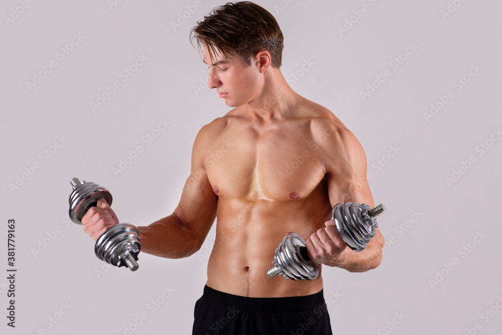 Powerful handsome young man with bare torso and prominent muscles ...