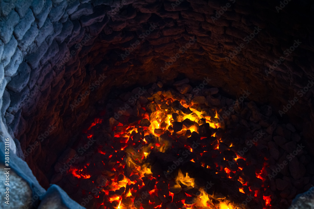 Traditional limestone kiln in Sri Lanka. Lime pit firing Stock Photo ...