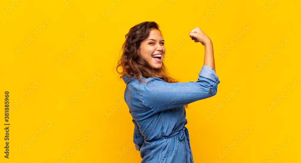 feeling happy, satisfied and powerful, flexing fit and muscular biceps ...