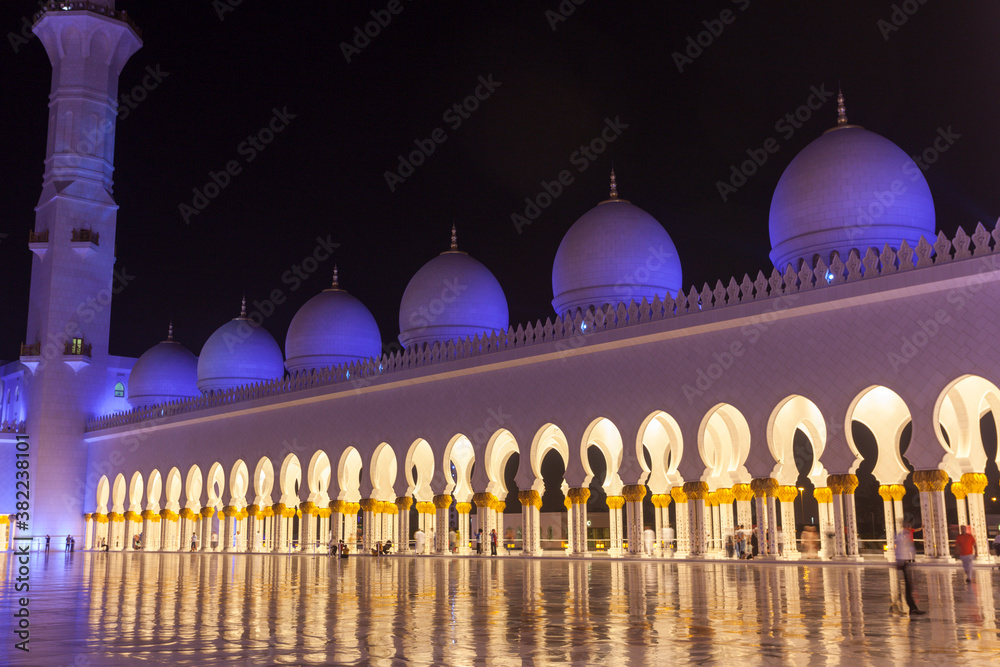 Sheikh Zayed Grand Mosque at night time, lightened. People are in ...