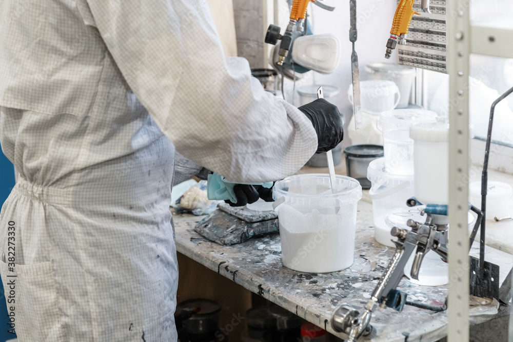 Crop mechanic mixing paint Stock Photo | Adobe Stock