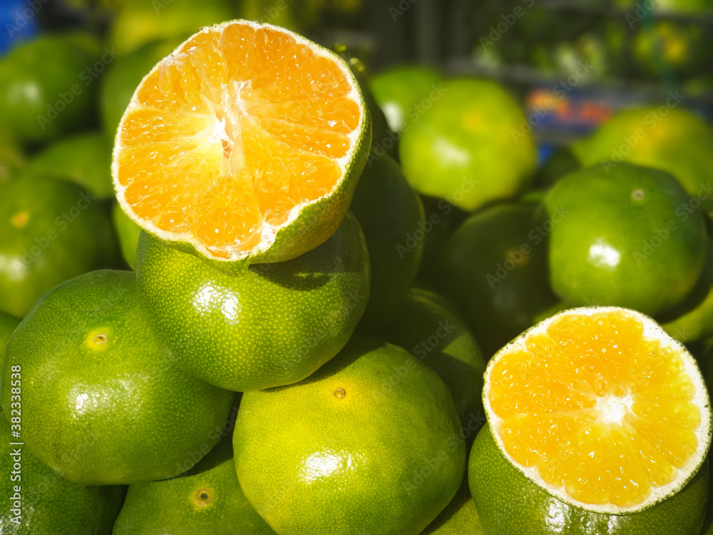 Healthy fresh green mandarins on the countertop at local fruit market ...