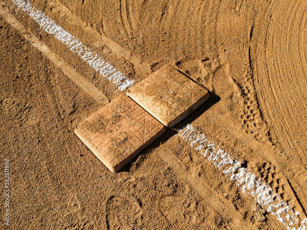 Detail of first base and freshly painted boundary line on baseball ...