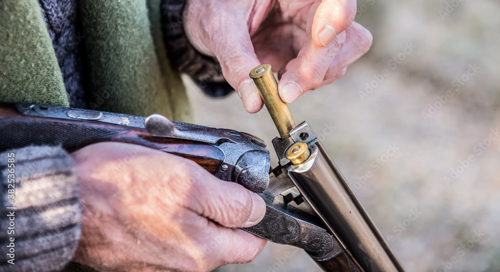 Old man putting ammunition in a hunting rifle-(loading shotgun) Stock ...