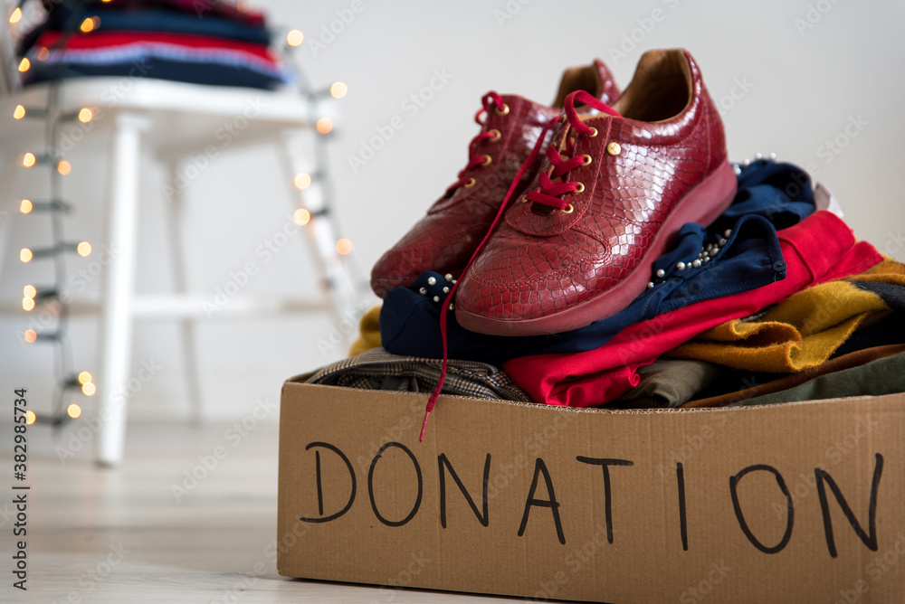 Cardboard donation box full with clothes and shoes. Concept of charity ...