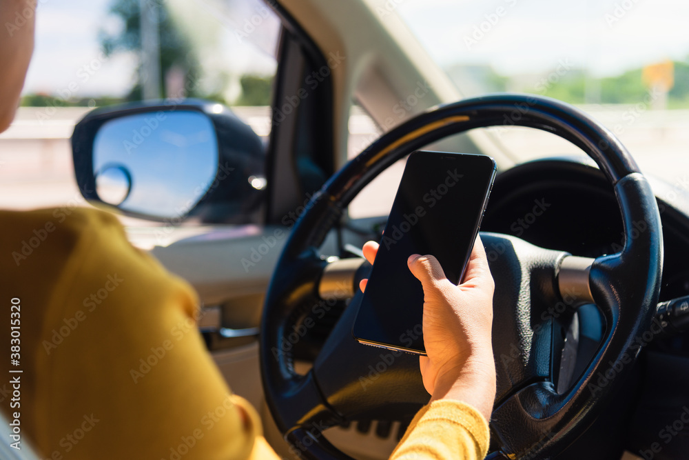 Asian woman inside a car and using a hand holding mobile smartphone ...