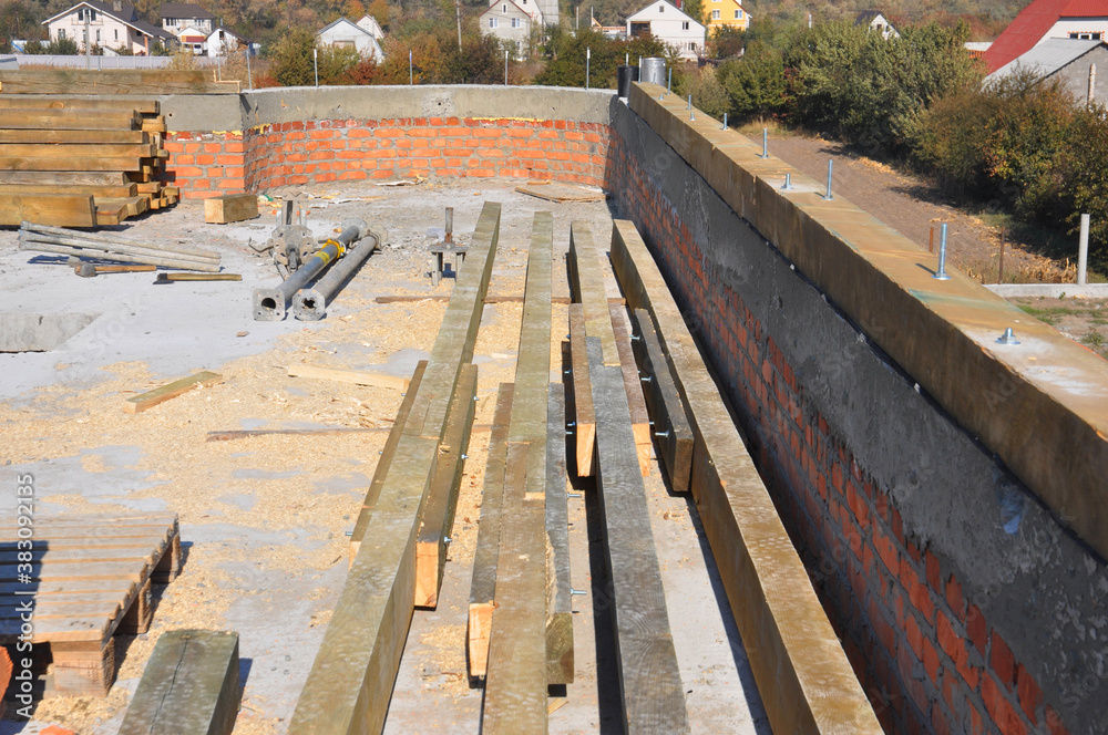 The beginning of roof framing and construction with roof beams ready ...