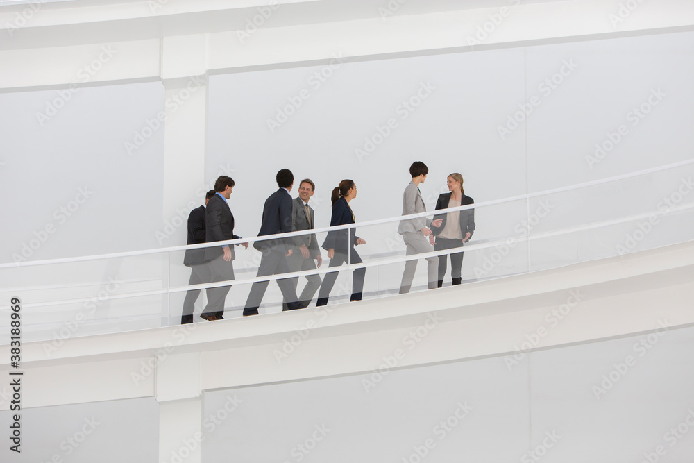 Business people walking on modern ramp Stock Photo | Adobe Stock