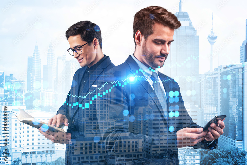 Two entrepreneurs in suits working on new venture capital and hi-tech ...