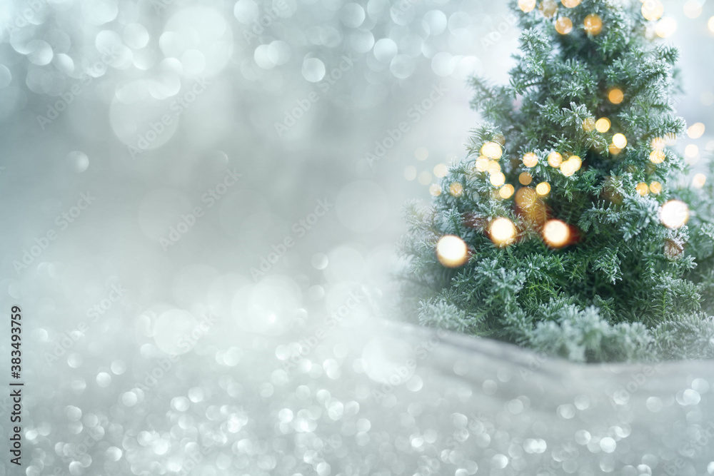 Christmas winter bokeh background. Christmas tree with snow and abstract bokeh lights. Festive ...