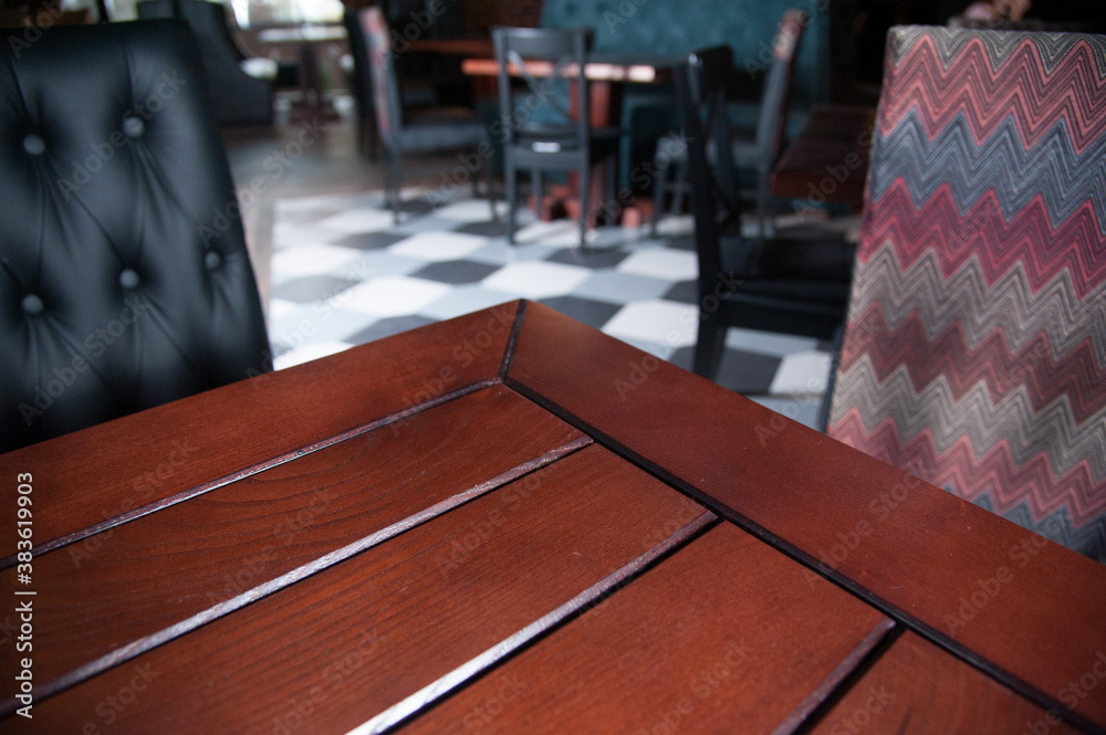 .corner of wooden table with background of pub or bar, cafe. empty ...