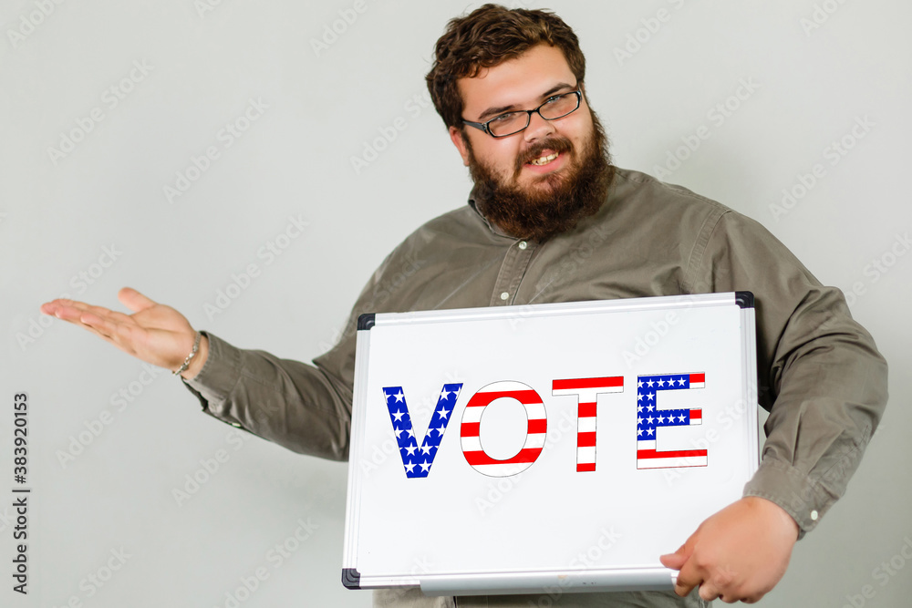 Photo Stock Man shows board with Vote sign. Voting concept. Make the ...