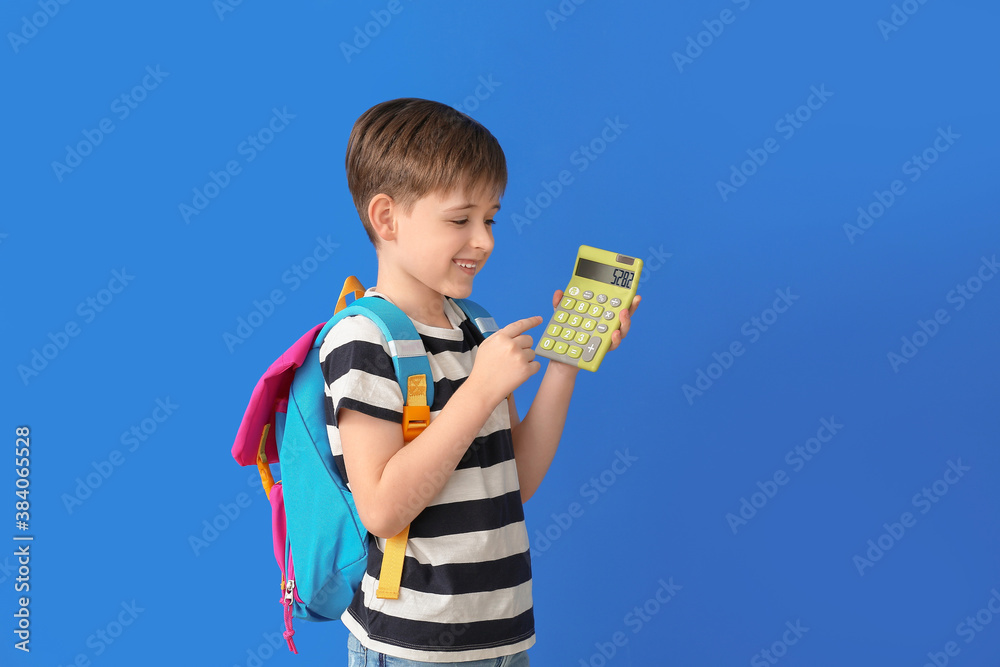Little schoolboy with calculator on color background Stock Photo ...