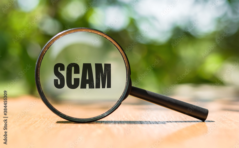 SCAM text on magnifier glass. Scam alert word concept, a Stock Photo ...