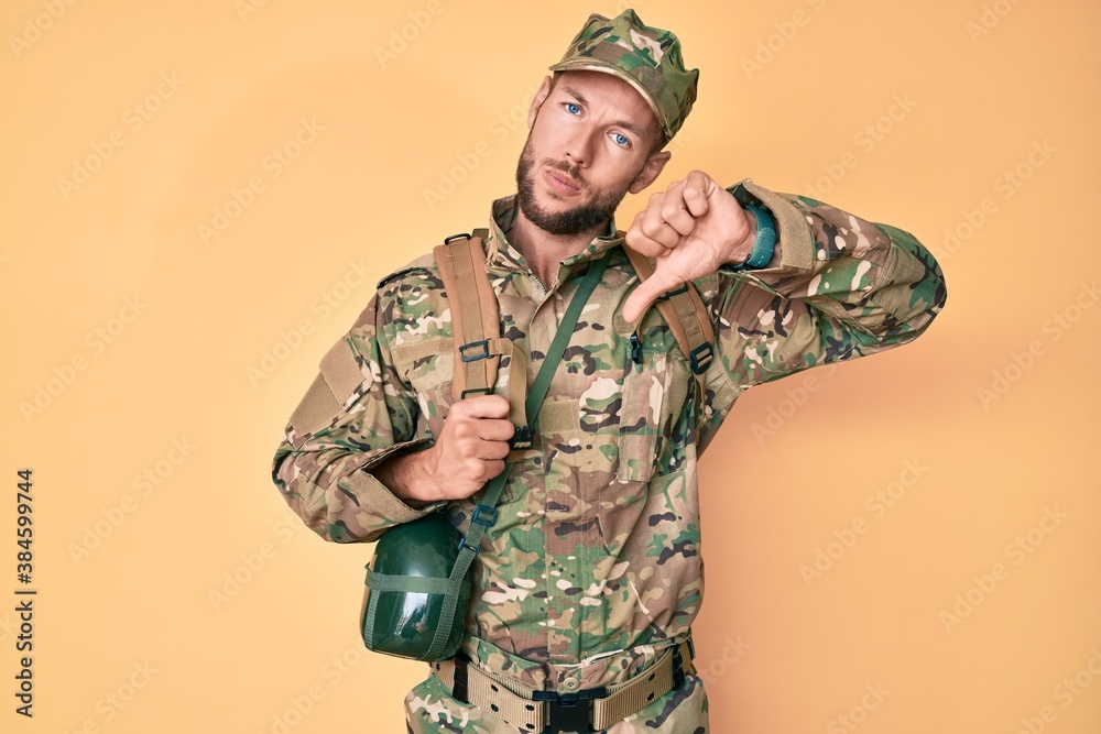 Young caucasian man wearing camouflage army uniform and canteen with ...