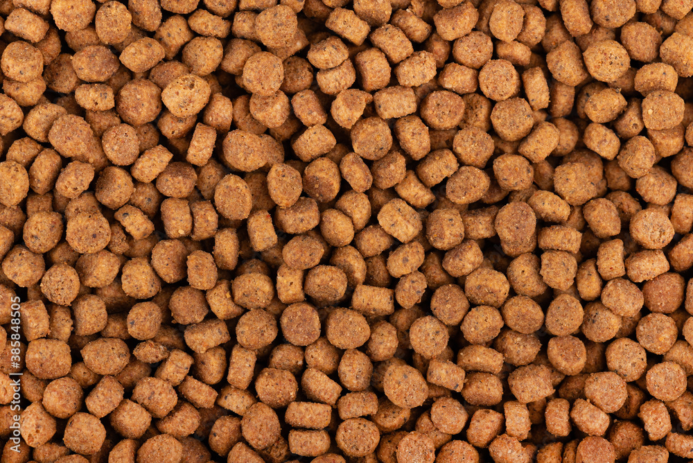 Dry pet food background. Pile of granulated animal feeds. Granules of ...