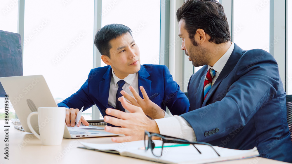 Two business people talk project strategy at office meeting room ...