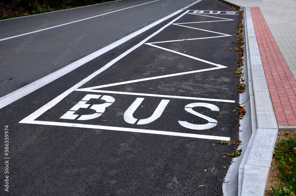Foto de Stock bus stop consisting of a reserved place with the word bus ...