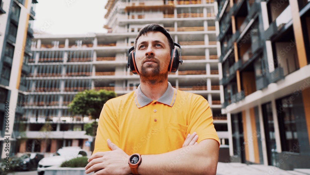 Man wearing safety equipment hearing protection. Worker wearing noise ...