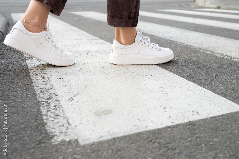 female feet crossing the crosswalk Stock Photo | Adobe Stock