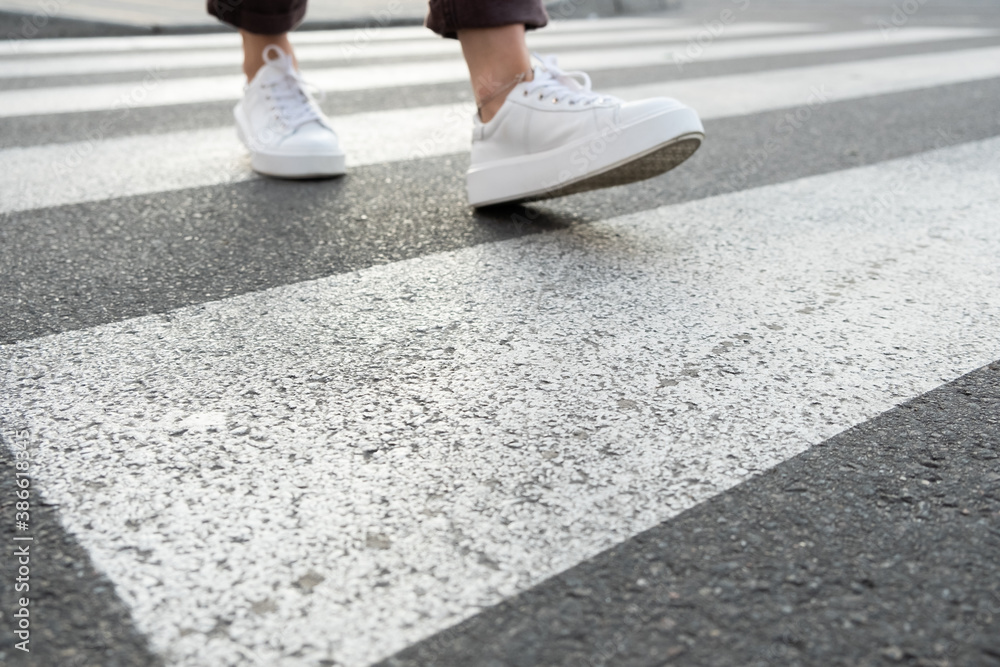 female feet crossing the crosswalk Stock Photo | Adobe Stock