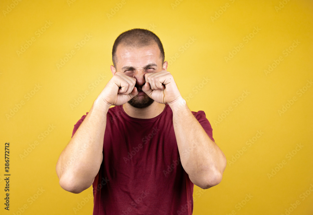 Russian man wearing basic red t-shirt over yellow insolated background ...