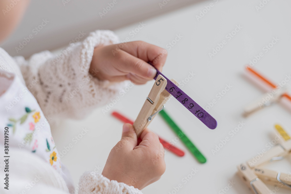 The child using craft sticks for learning numbers, early childhood ...