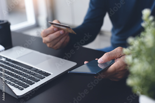 Man using credit card via internet banking apps on mobile phone for ...