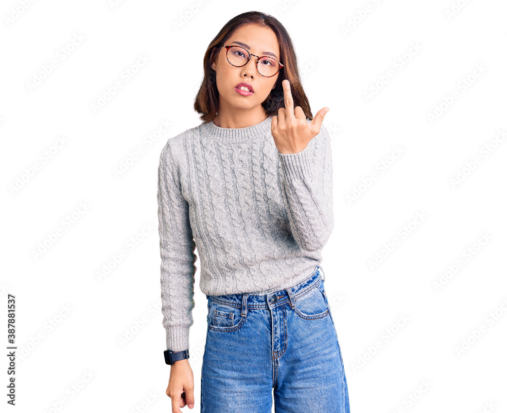 Young beautiful chinese girl wearing casual clothes showing middle ...