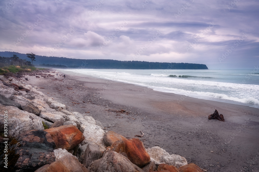 Surreal foggy and cloudy sunset at Bruce Bay beach with rocks in the ...